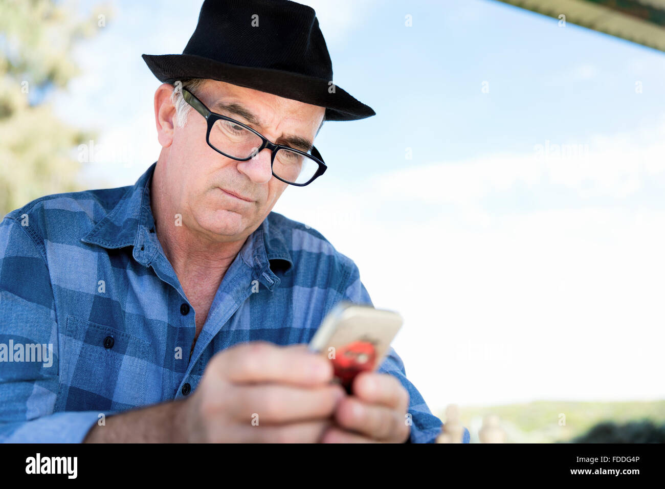 Portrait of an old man with his mobile phone outdoors Stock Photo - Alamy