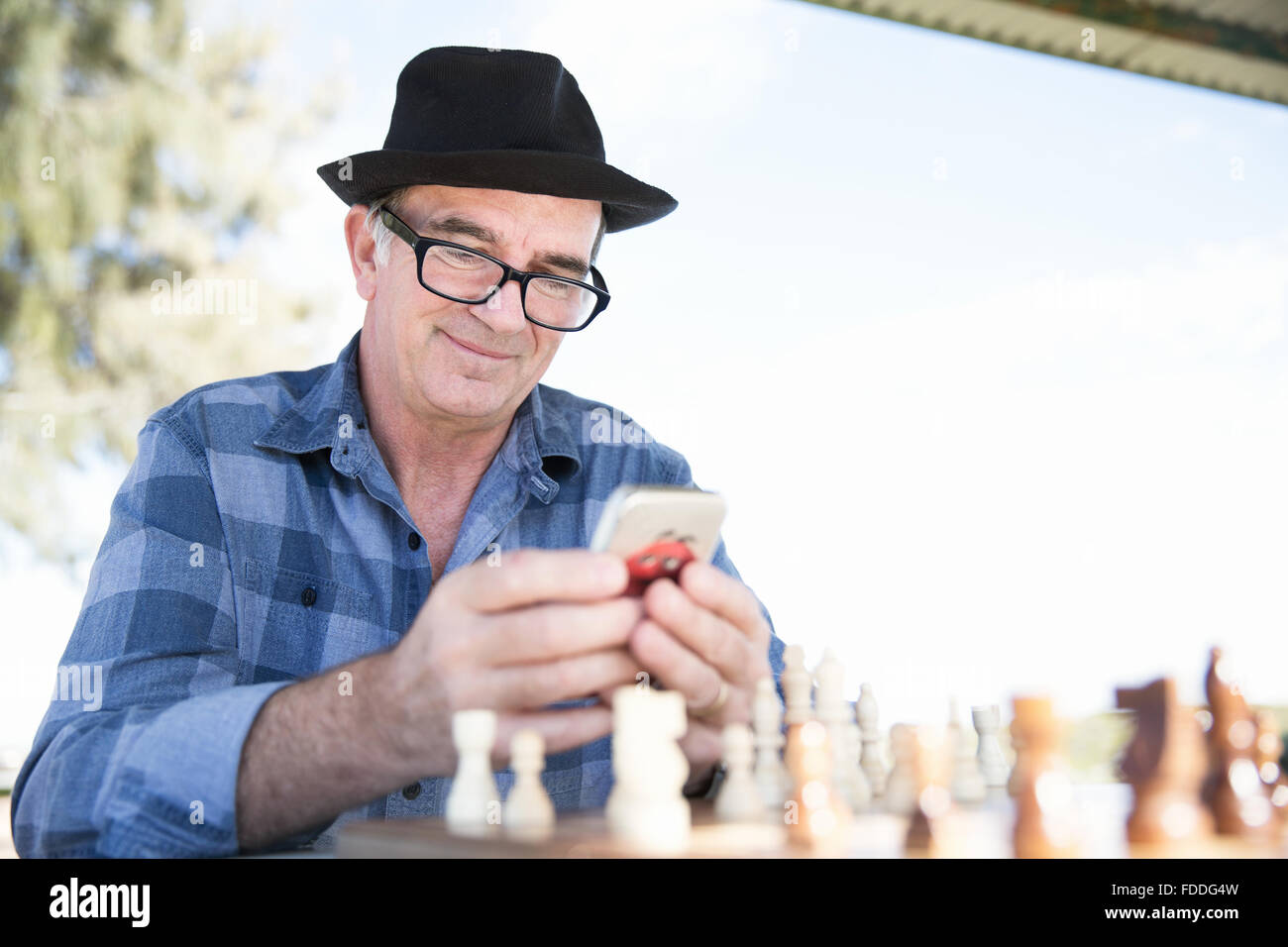 Portrait of an old man with his mobile phone outdoors Stock Photo - Alamy