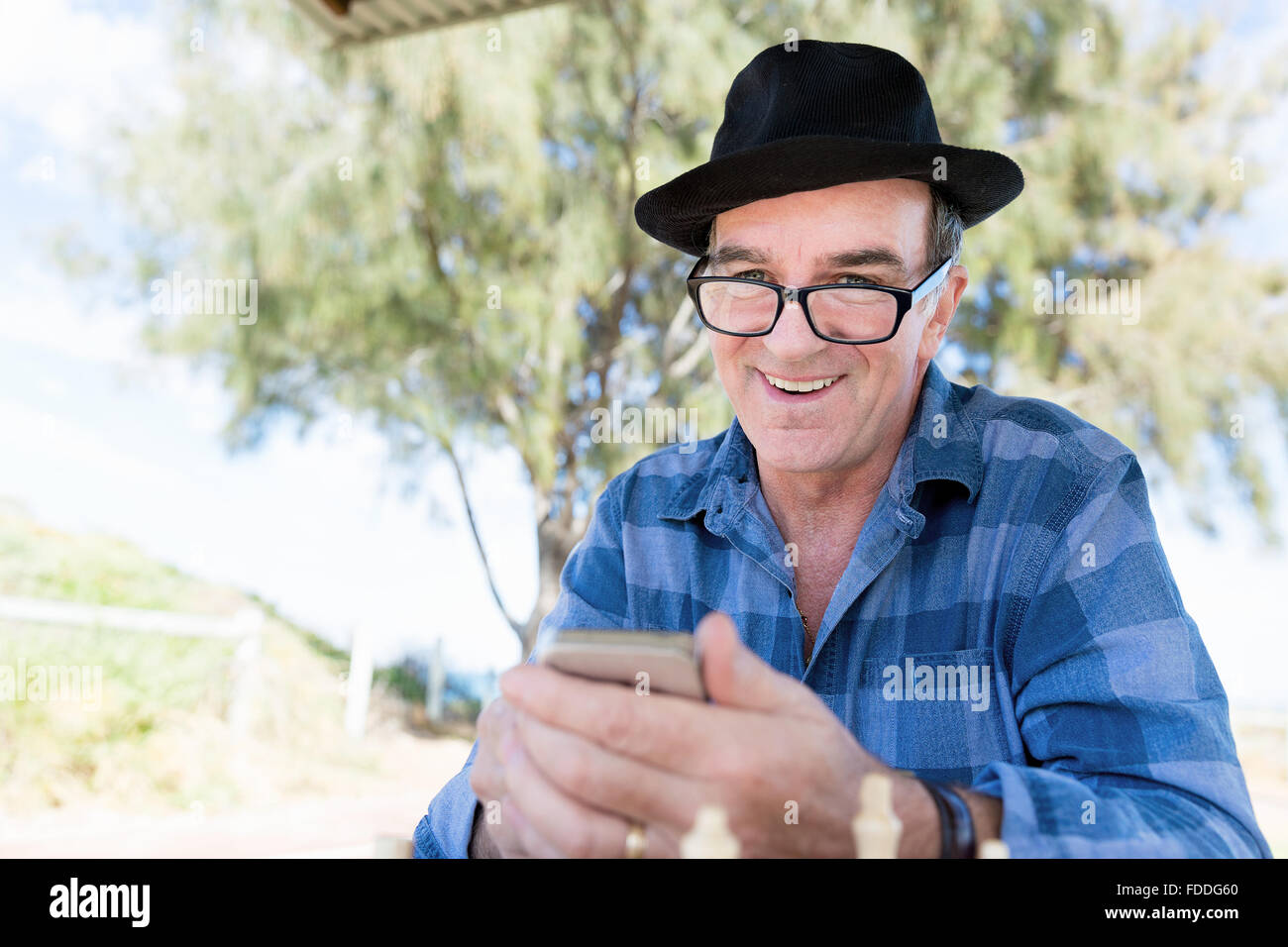 Portrait of an old man with his mobile phone outdoors Stock Photo - Alamy