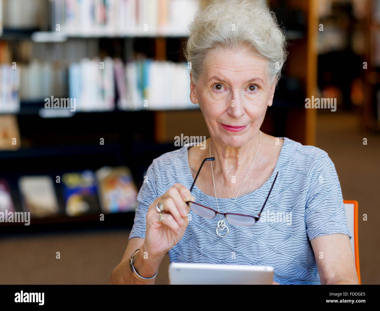 Elderly lady working with tablet Stock Photo - Alamy