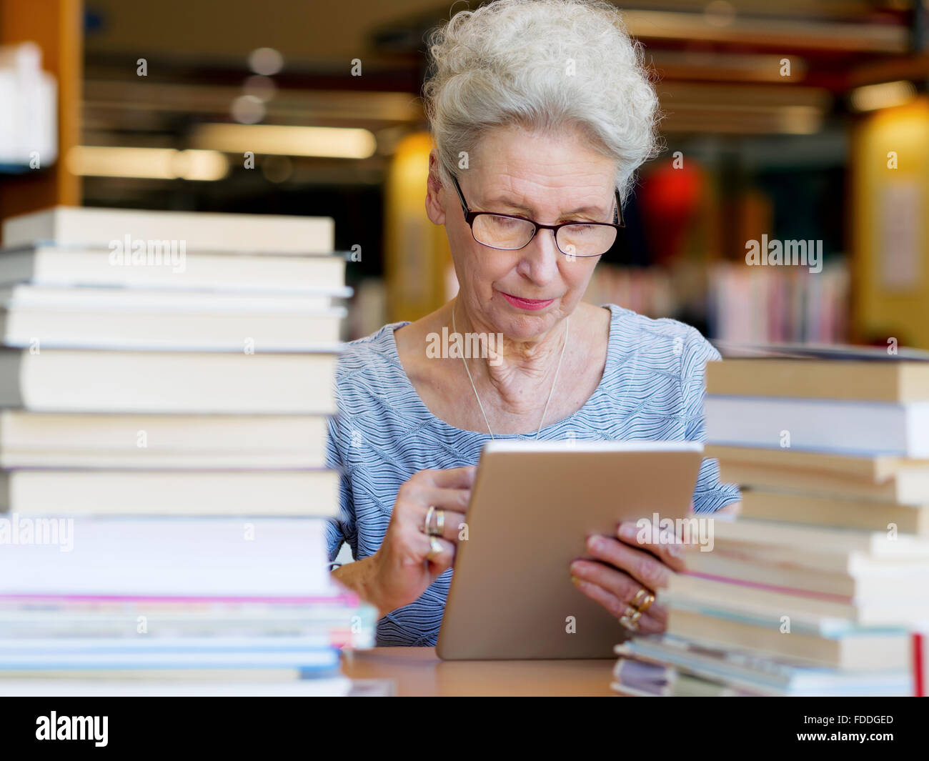 Elderly lady working with tablet Stock Photo - Alamy