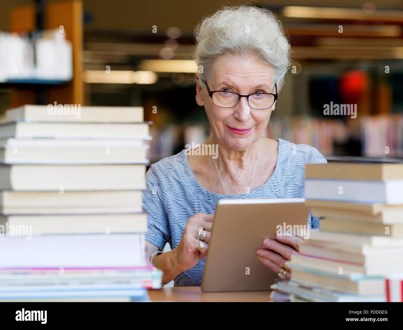 Elderly lady working with tablet Stock Photo - Alamy