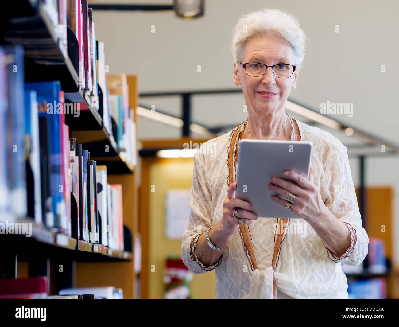 Elderly lady working with tablet Stock Photo - Alamy