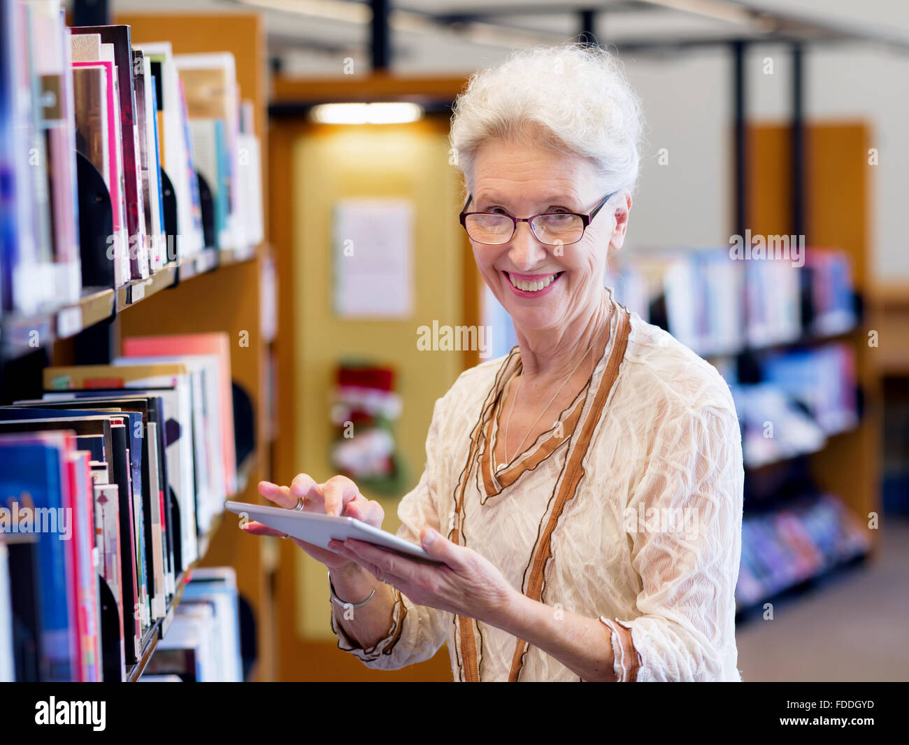 Elderly lady working with tablet Stock Photo - Alamy