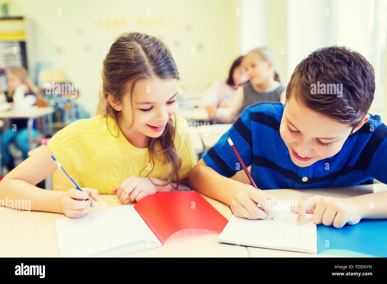 group of school kids writing test in classroom Stock Photo - Alamy