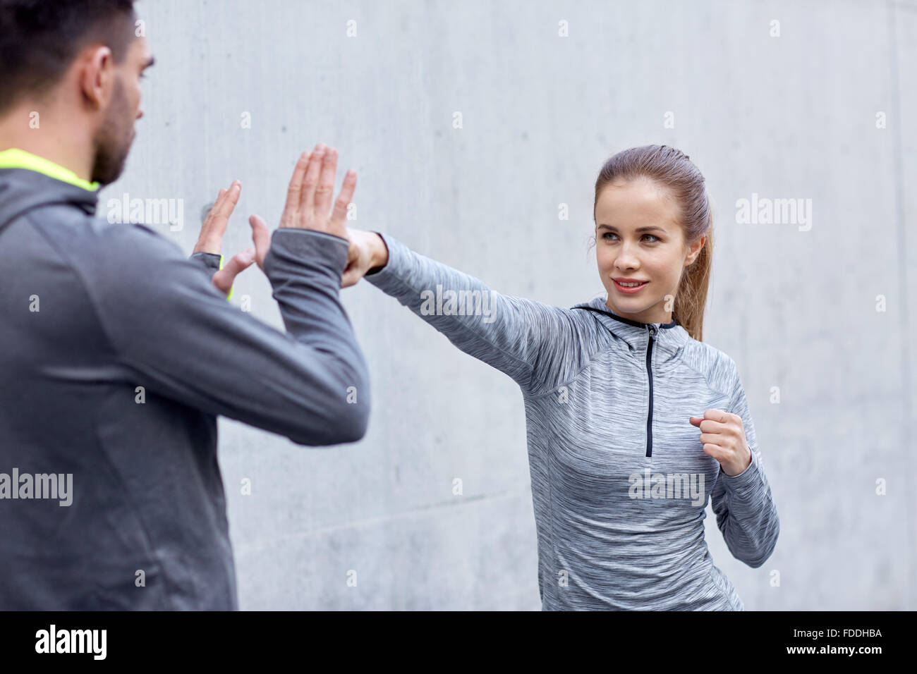 happy woman with coach working out strike outdoors Stock Photo - Alamy