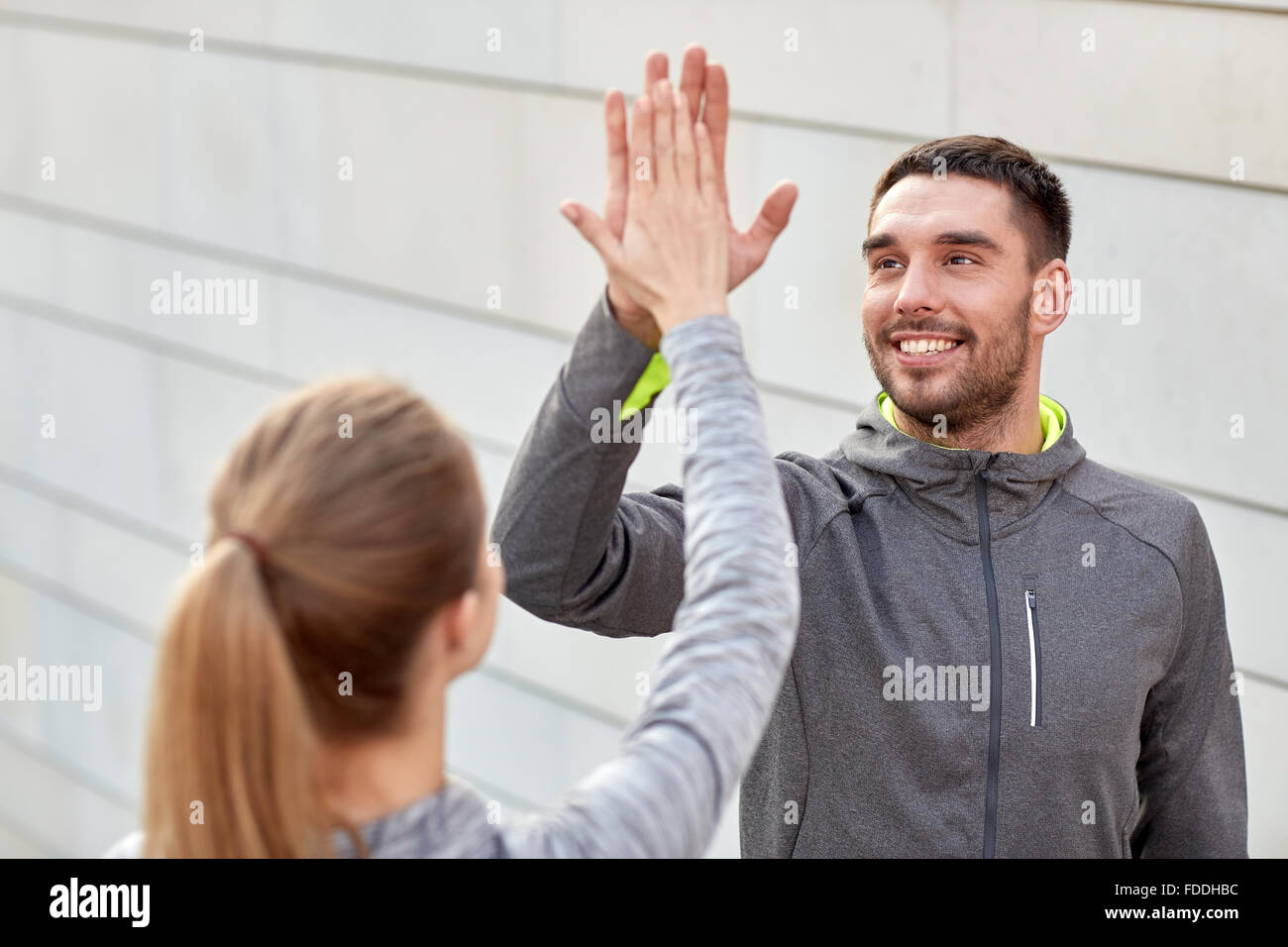 happy couple giving high five outdoors Stock Photo - Alamy