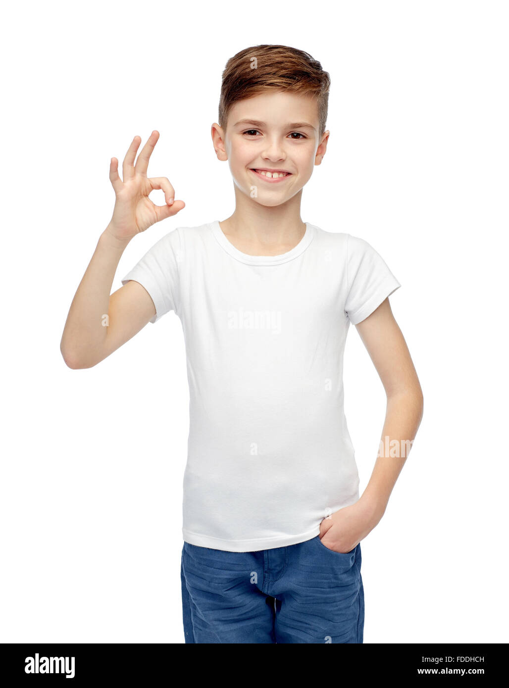 happy boy in white t-shirt showing ok hand sign Stock Photo - Alamy