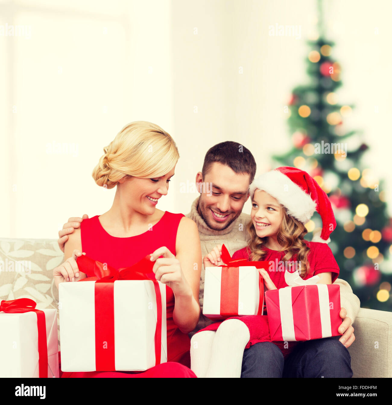 happy family opening gift boxes Stock Photo - Alamy
