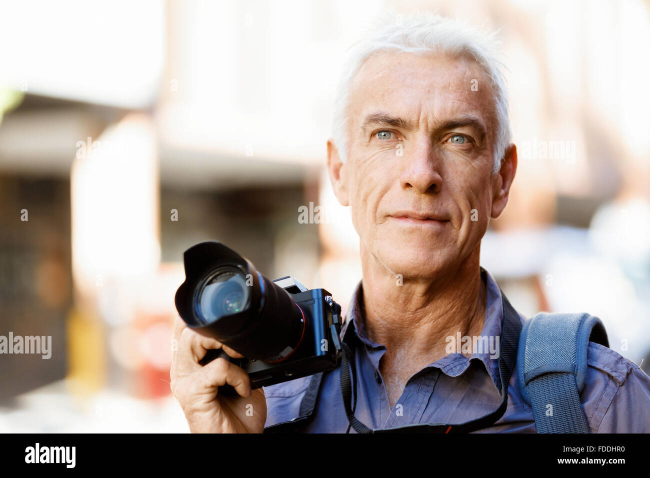 Senior man with camera in city Stock Photo - Alamy