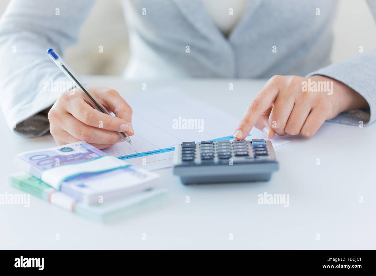 close up of hands counting money with calculator Stock Photo - Alamy