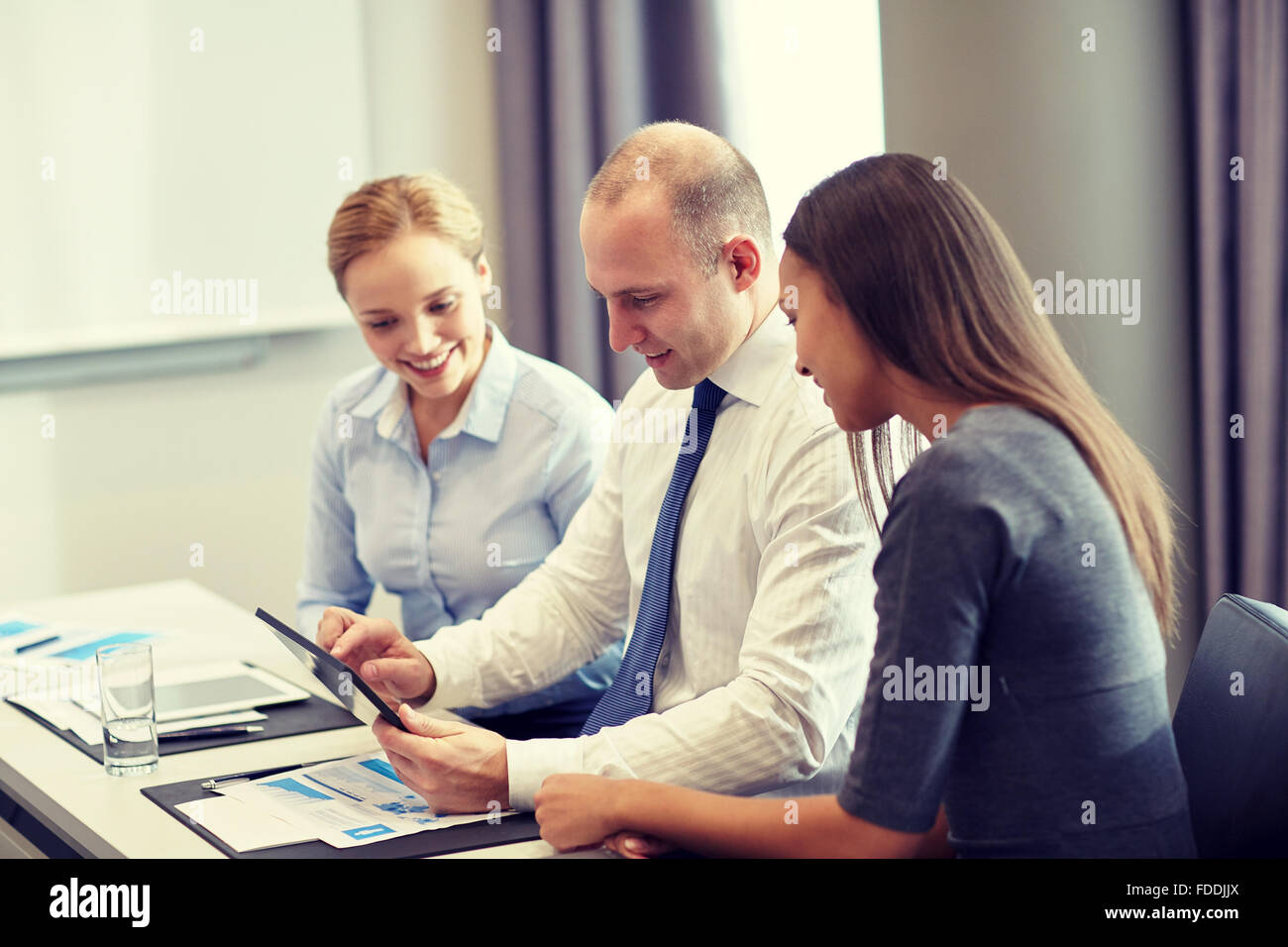 smiling business people with tablet pc in office Stock Photo - Alamy