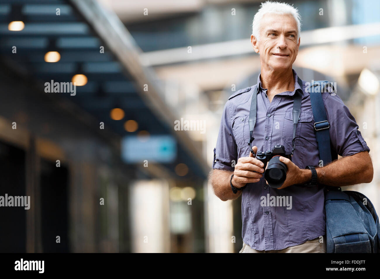 Senior man with camera in city Stock Photo - Alamy