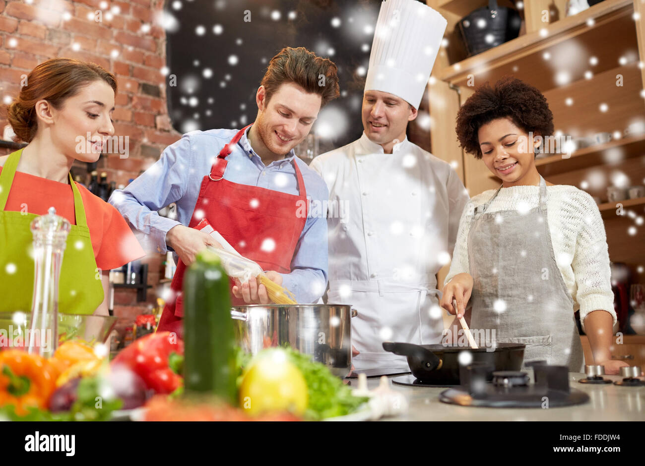 happy friends and chef cook cooking in kitchen Stock Photo - Alamy