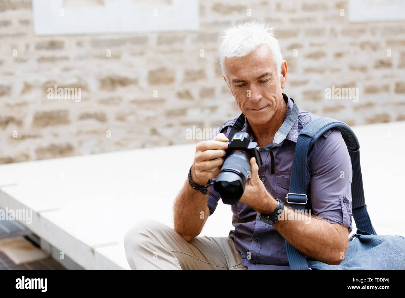 Senior man with camera in city Stock Photo - Alamy
