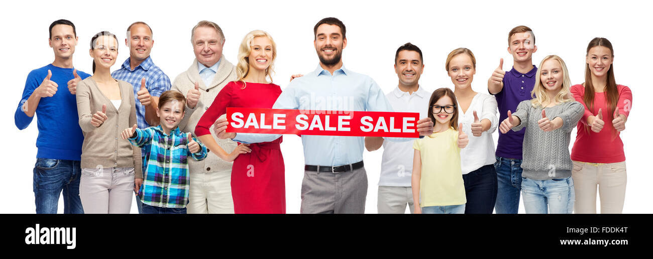 happy people with red sale sign showing thumbs up Stock Photo - Alamy