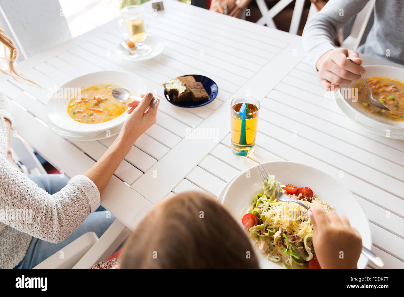 close up of family having dinner at restaurant Stock Photo - Alamy
