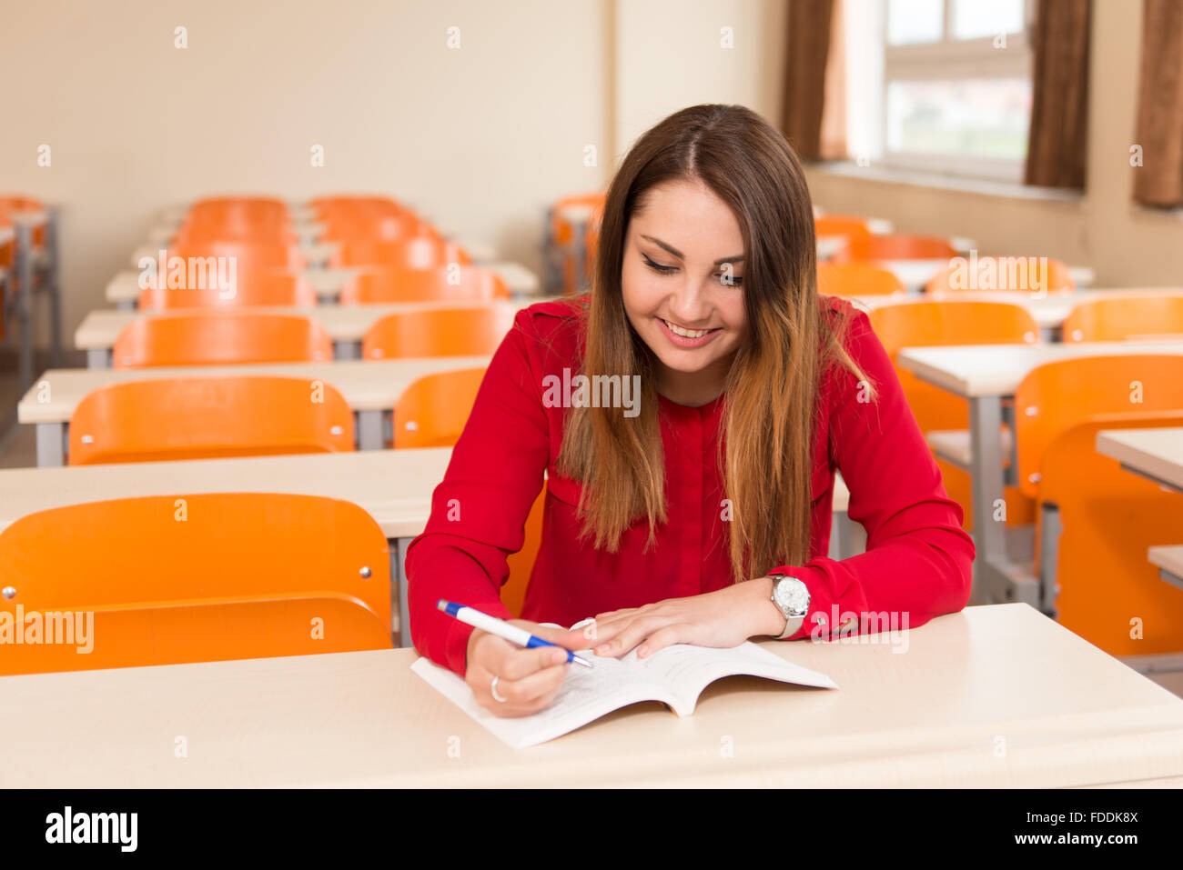 Sad girl sitting alone in classroom hi-res stock photography and images ...