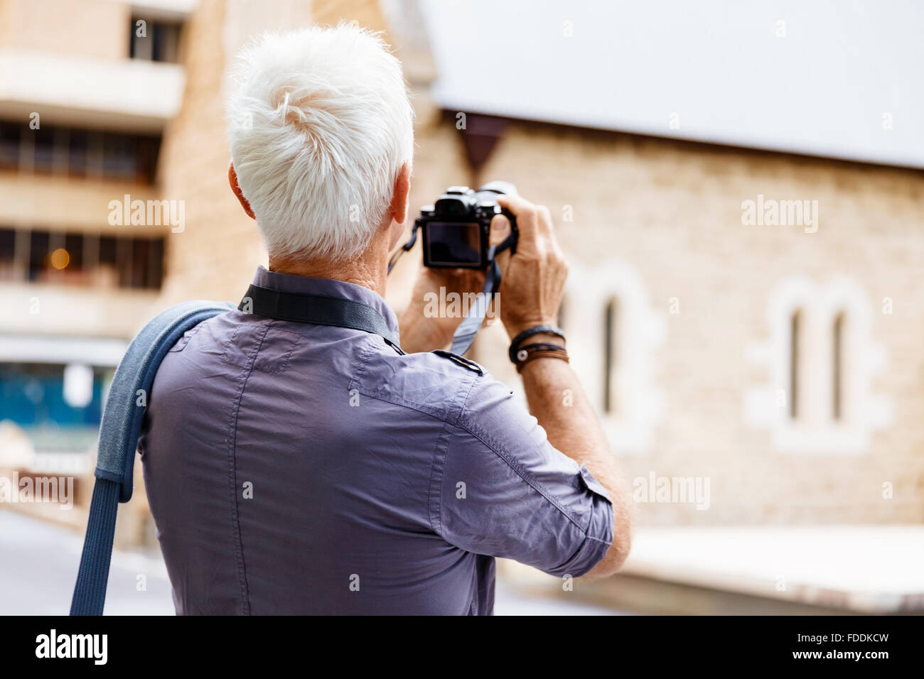 Senior man with camera in city Stock Photo - Alamy
