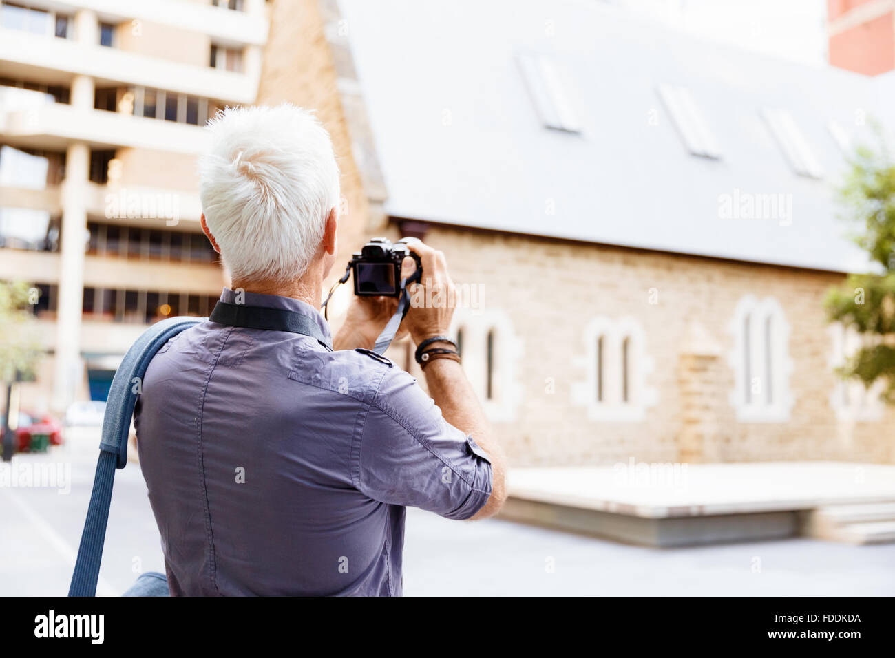 Senior man with camera in city Stock Photo - Alamy