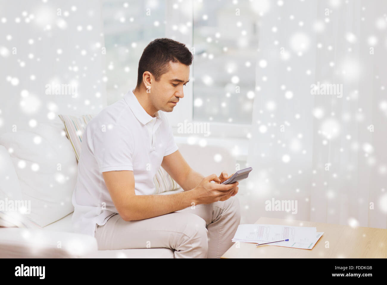 man with papers and calculator at home Stock Photo - Alamy