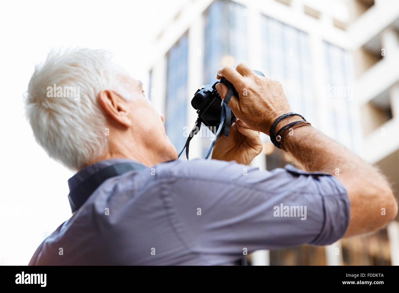 Senior man with camera in city Stock Photo - Alamy