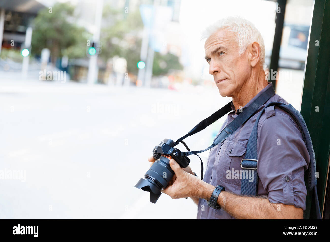 Senior man with camera in city Stock Photo - Alamy