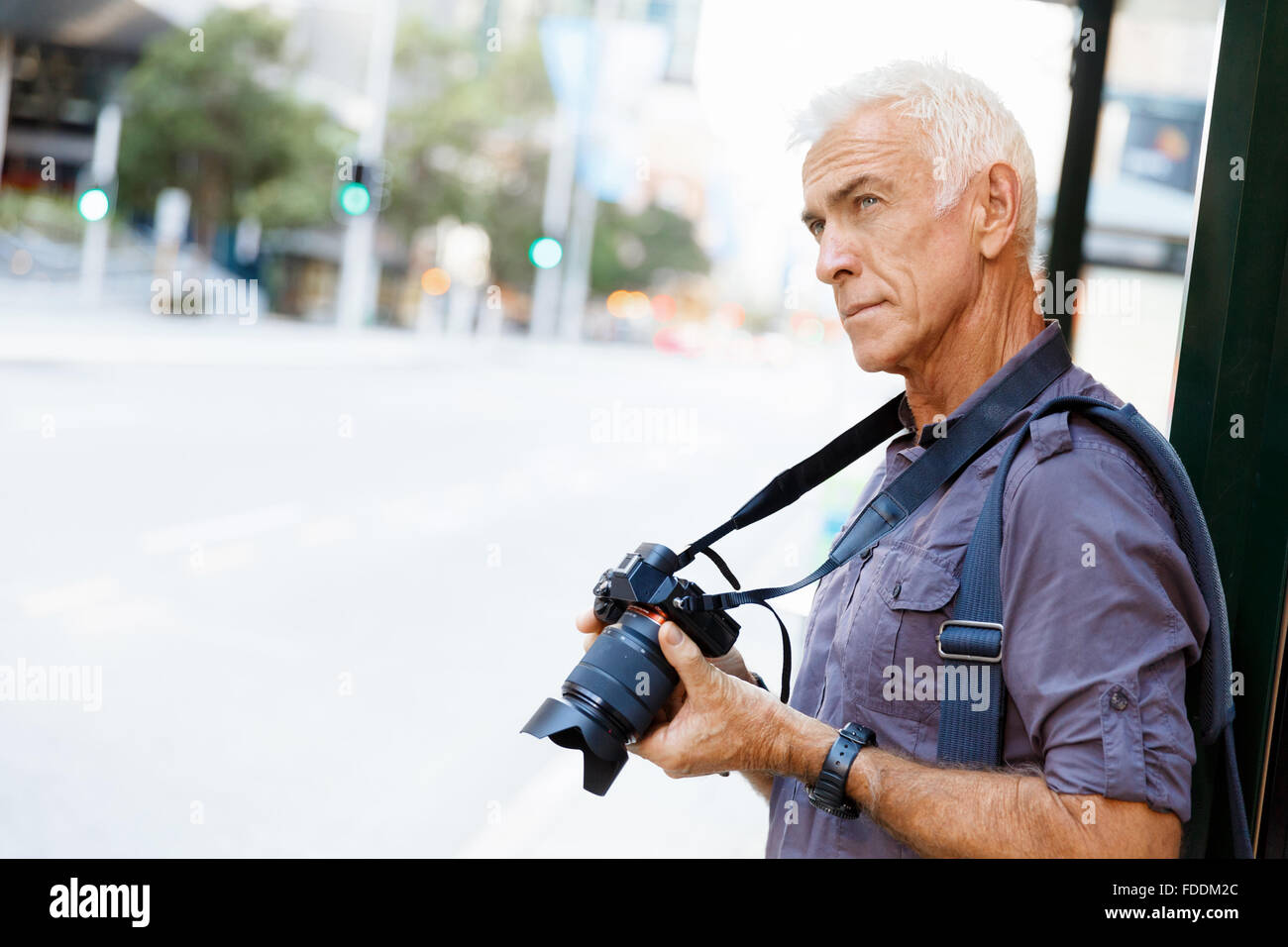 Senior man with camera in city Stock Photo - Alamy