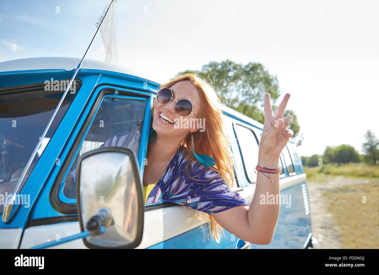 smiling young hippie woman driving minivan car Stock Photo - Alamy