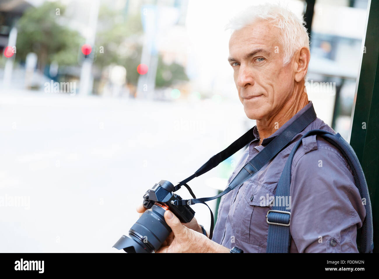Senior man with camera in city Stock Photo - Alamy