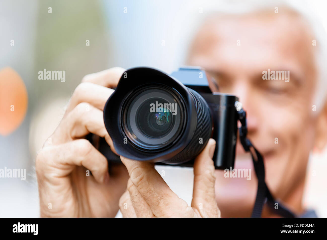 Senior man with camera in city Stock Photo - Alamy
