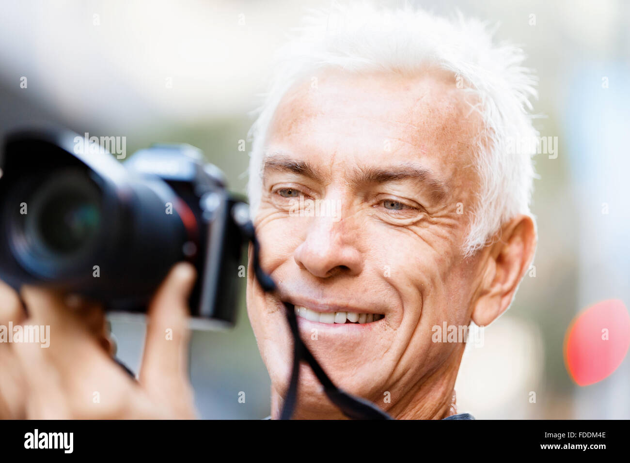 Senior man with camera in city Stock Photo - Alamy