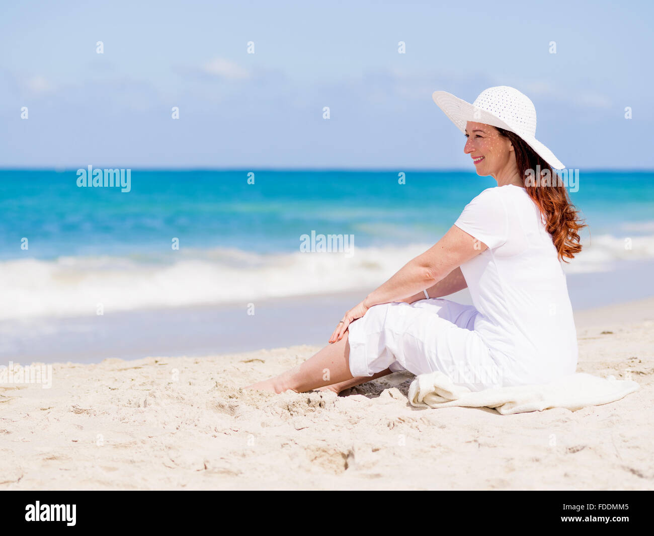 Woman in white clothes on the beach on sunny day Stock Photo - Alamy