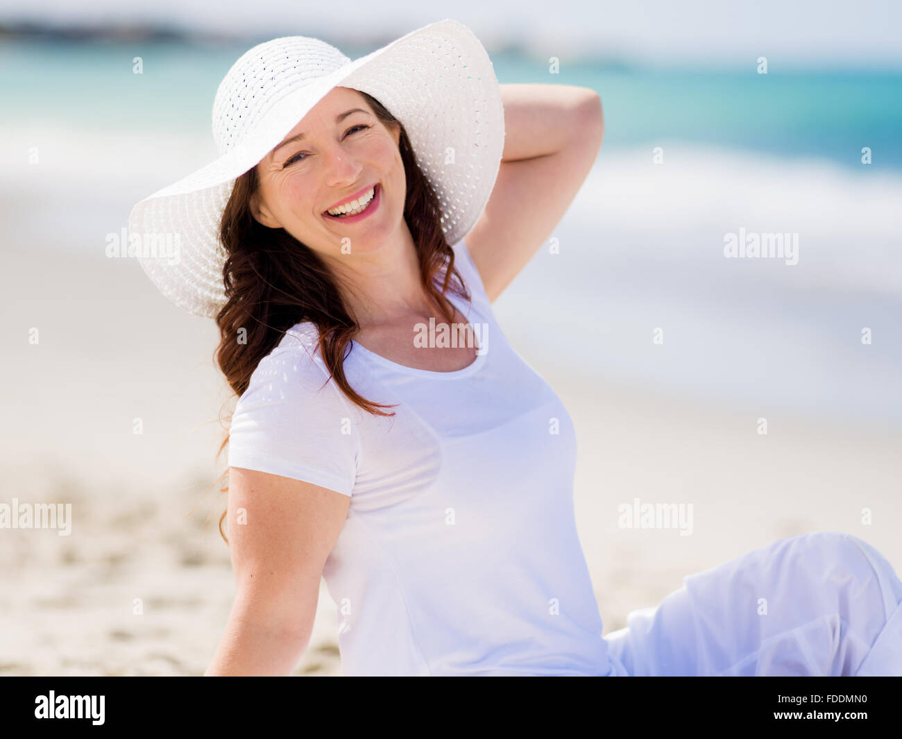 Woman in white clothes on the beach on sunny day Stock Photo - Alamy