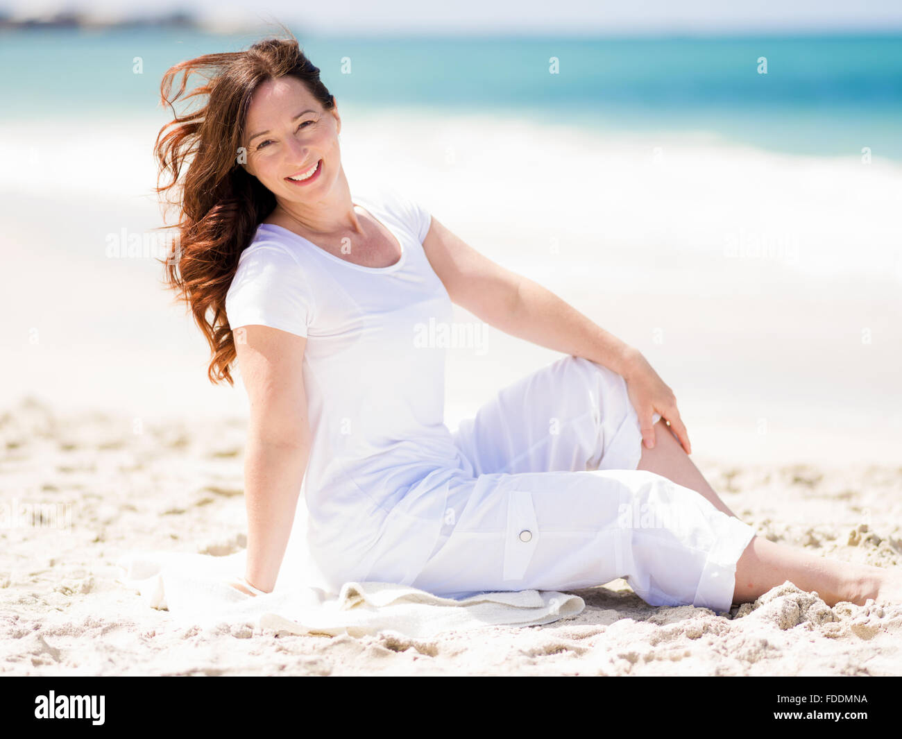 Woman in white clothes on the beach on sunny day Stock Photo - Alamy