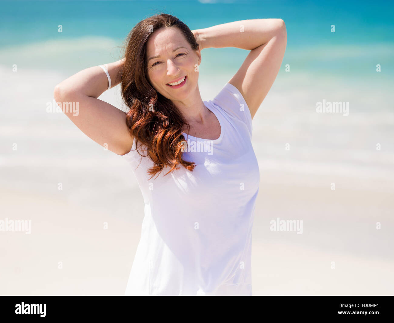 Woman in white clothes on the beach on sunny day Stock Photo - Alamy