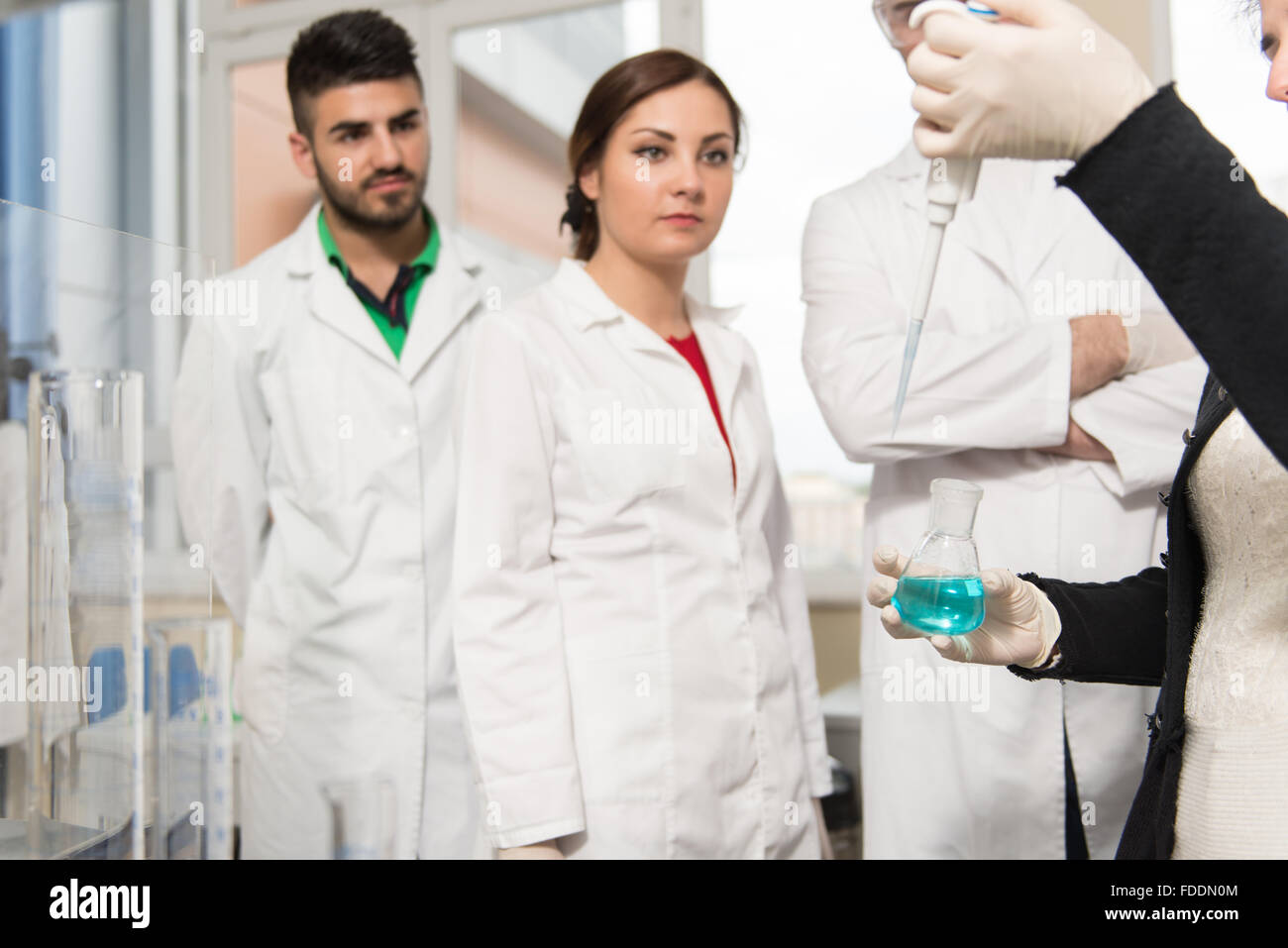 Group Of Students Scientists Conducting Research With Teacher In A Lab ...