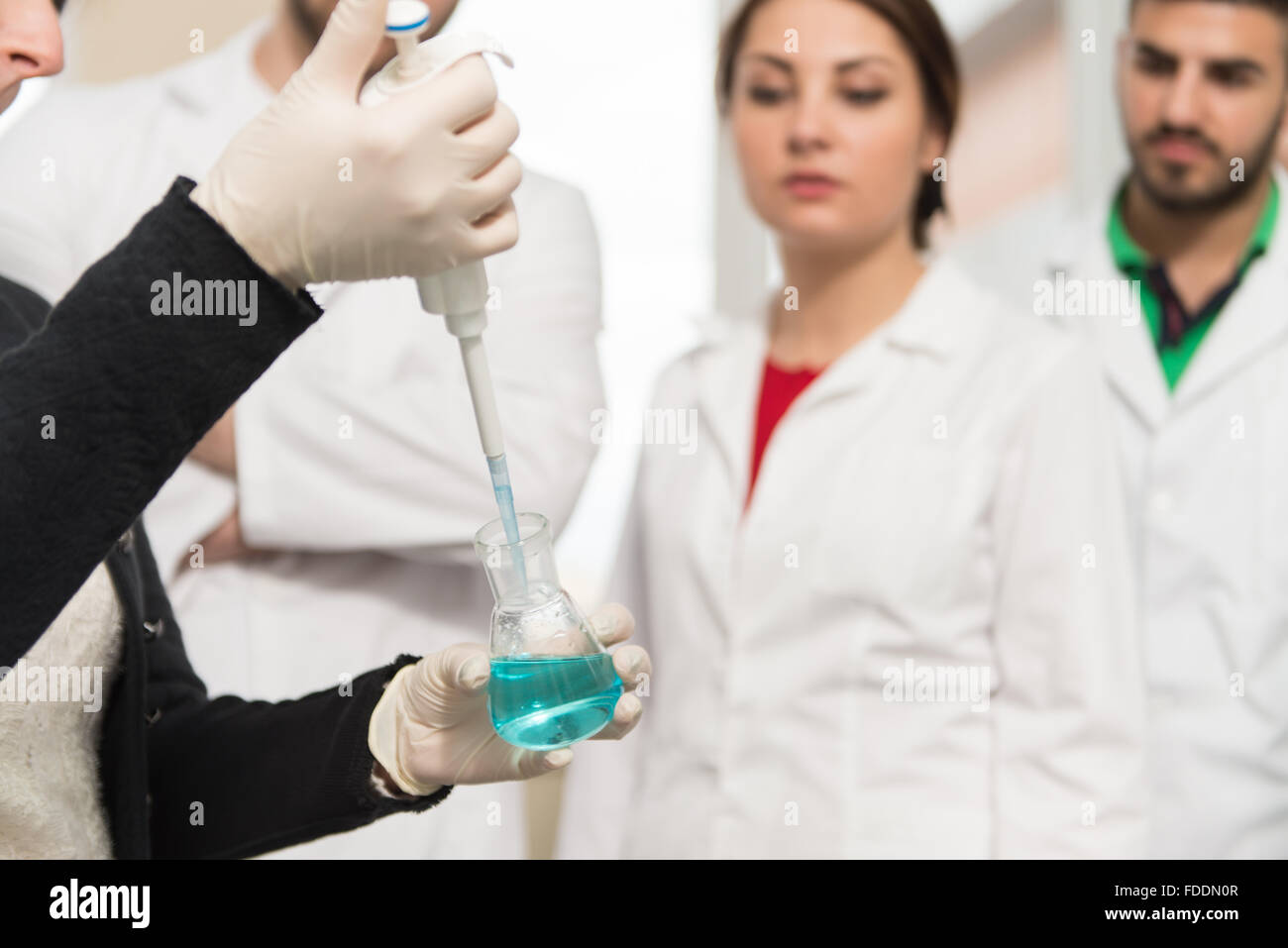 Group Of Students Scientists Conducting Research With Teacher In A Lab ...