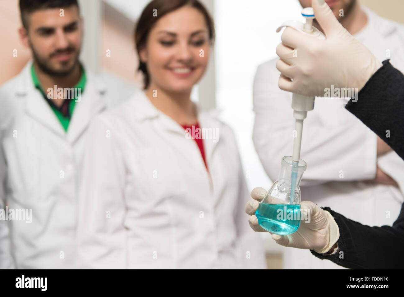 Group Of Students Scientists Conducting Research With Teacher In A Lab ...