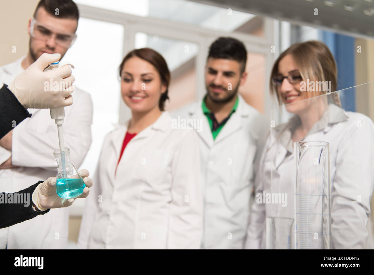 Group Of Students Scientists Conducting Research With Teacher In A Lab ...