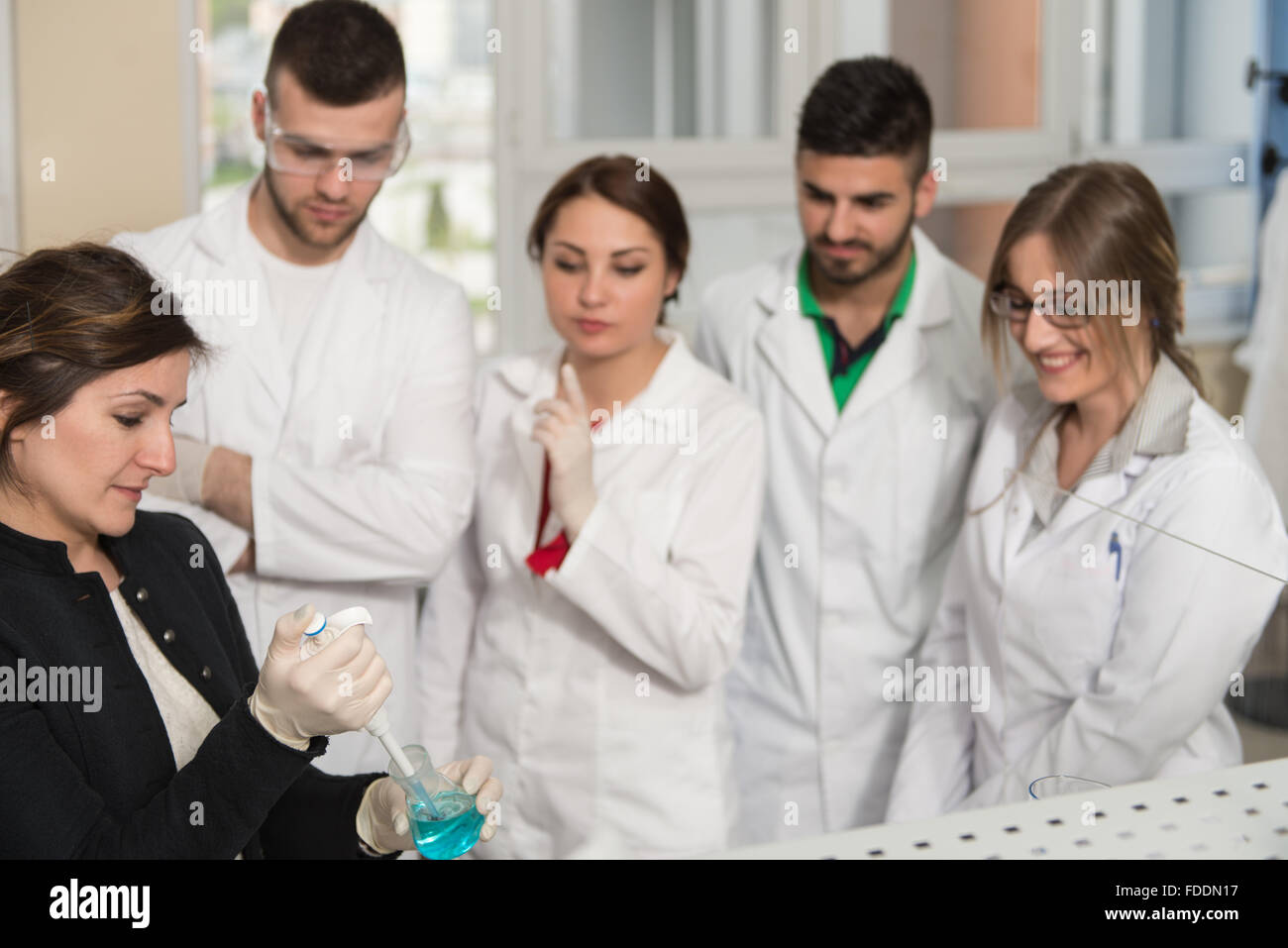Group Of Students Scientists Conducting Research With Teacher In A Lab ...