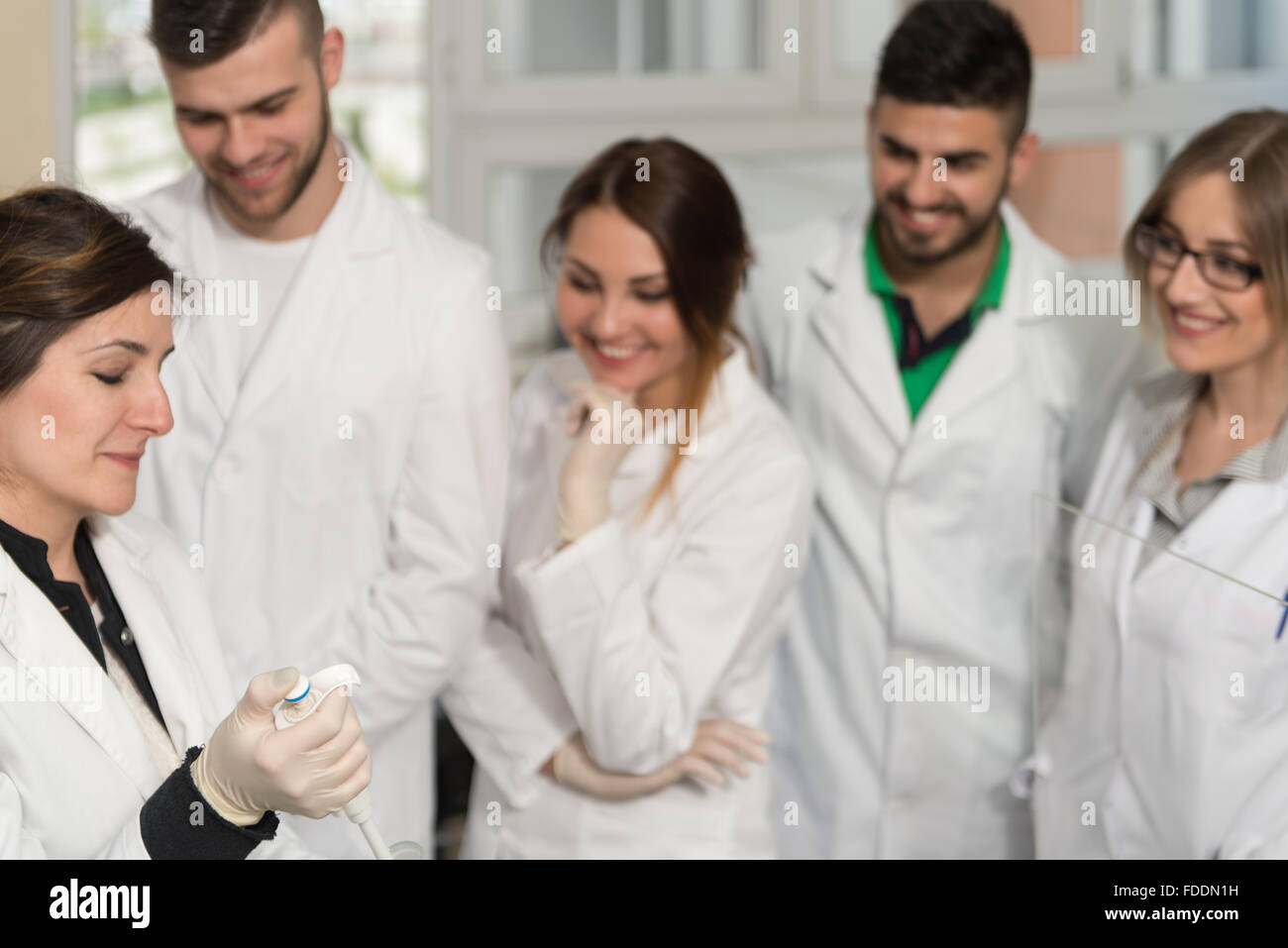 Group Of Students Scientists Conducting Research With Teacher In A Lab ...