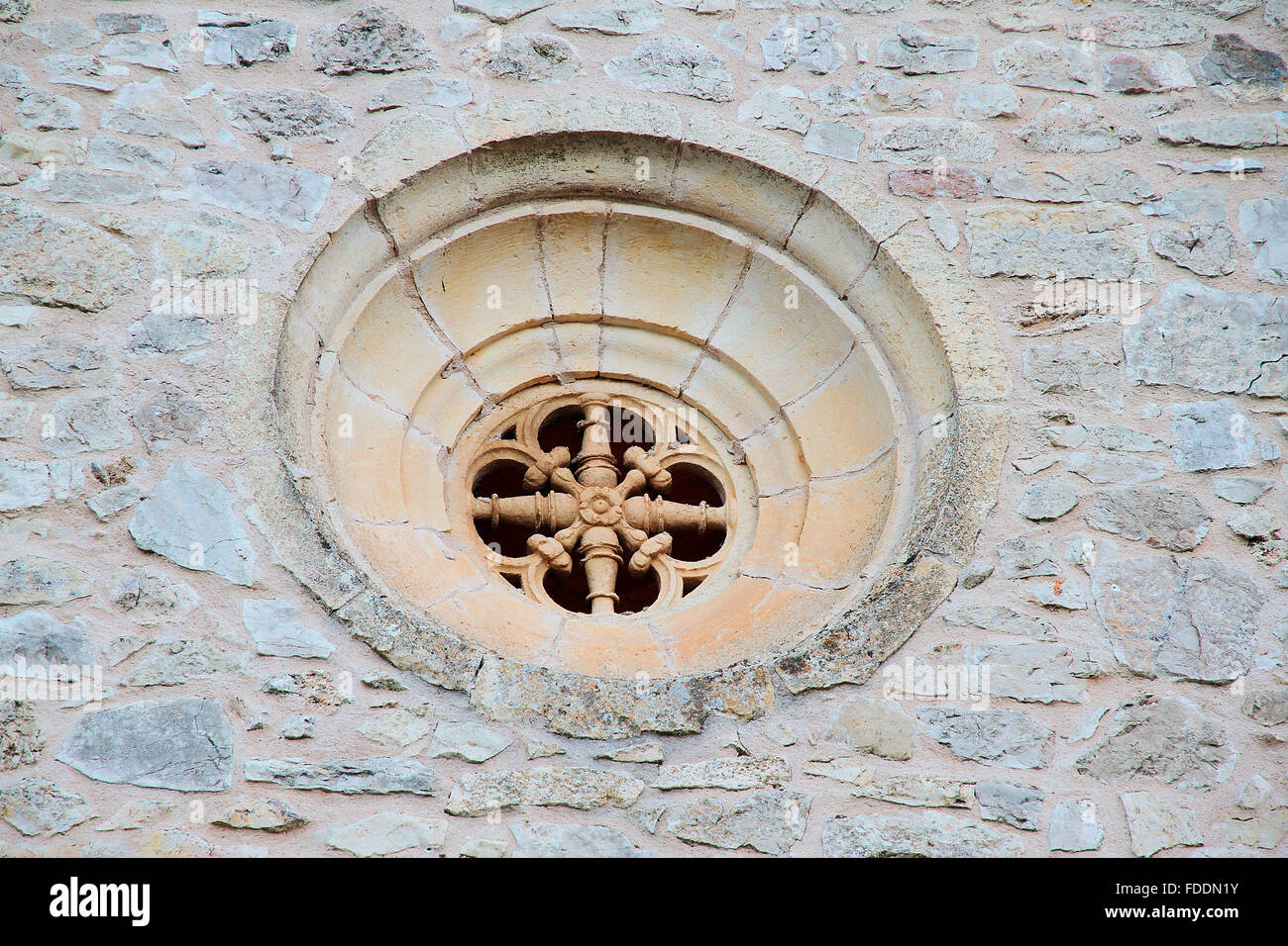 detail of a rose window on the facade of a church in Romanic style ...
