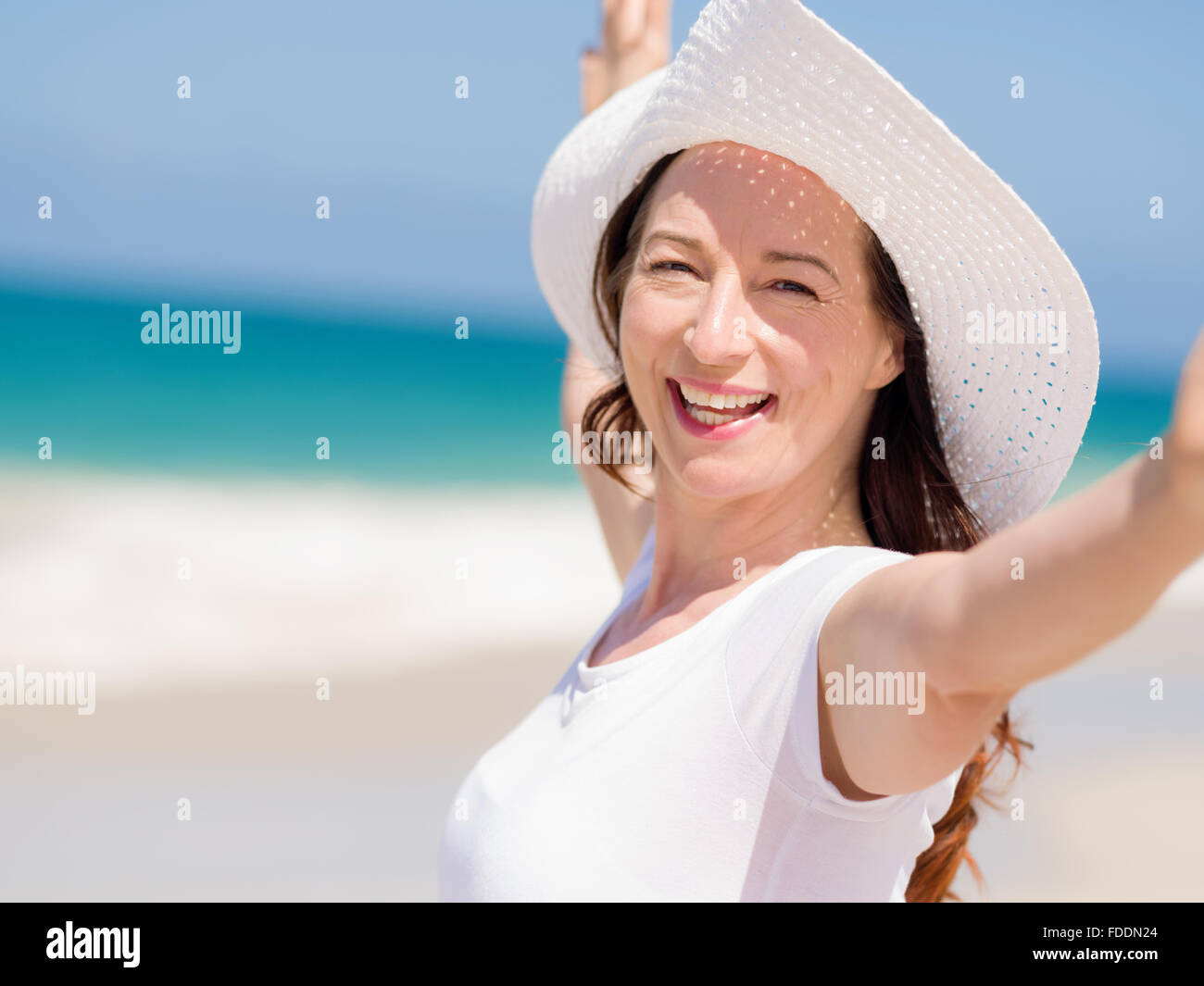 Woman in white clothes on the beach on sunny day Stock Photo - Alamy