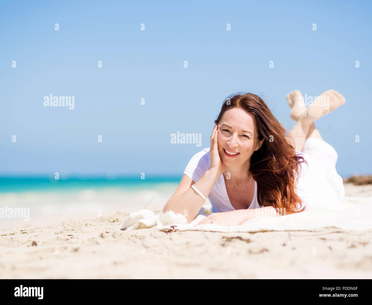 Woman in white clothes on the beach on sunny day Stock Photo - Alamy