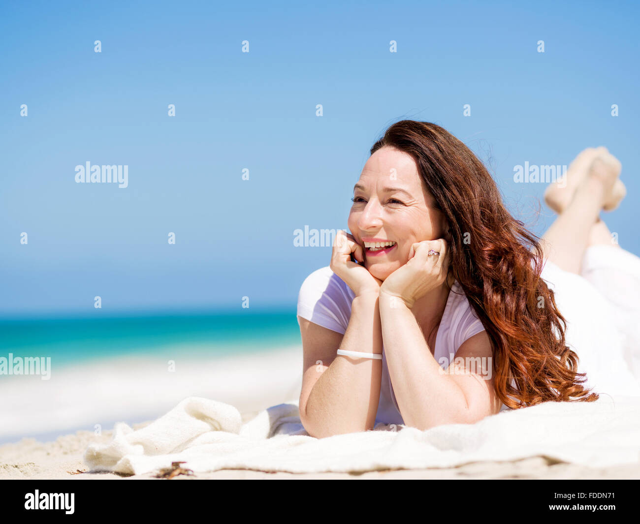 Woman in white clothes on the beach on sunny day Stock Photo - Alamy