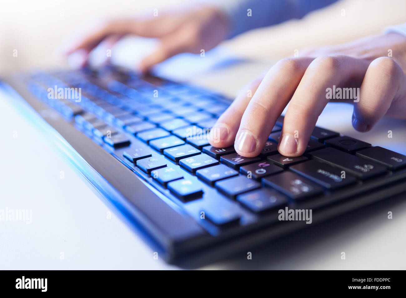 Click! Hands of a man on a keyboard with blue backlighting Stock Photo ...