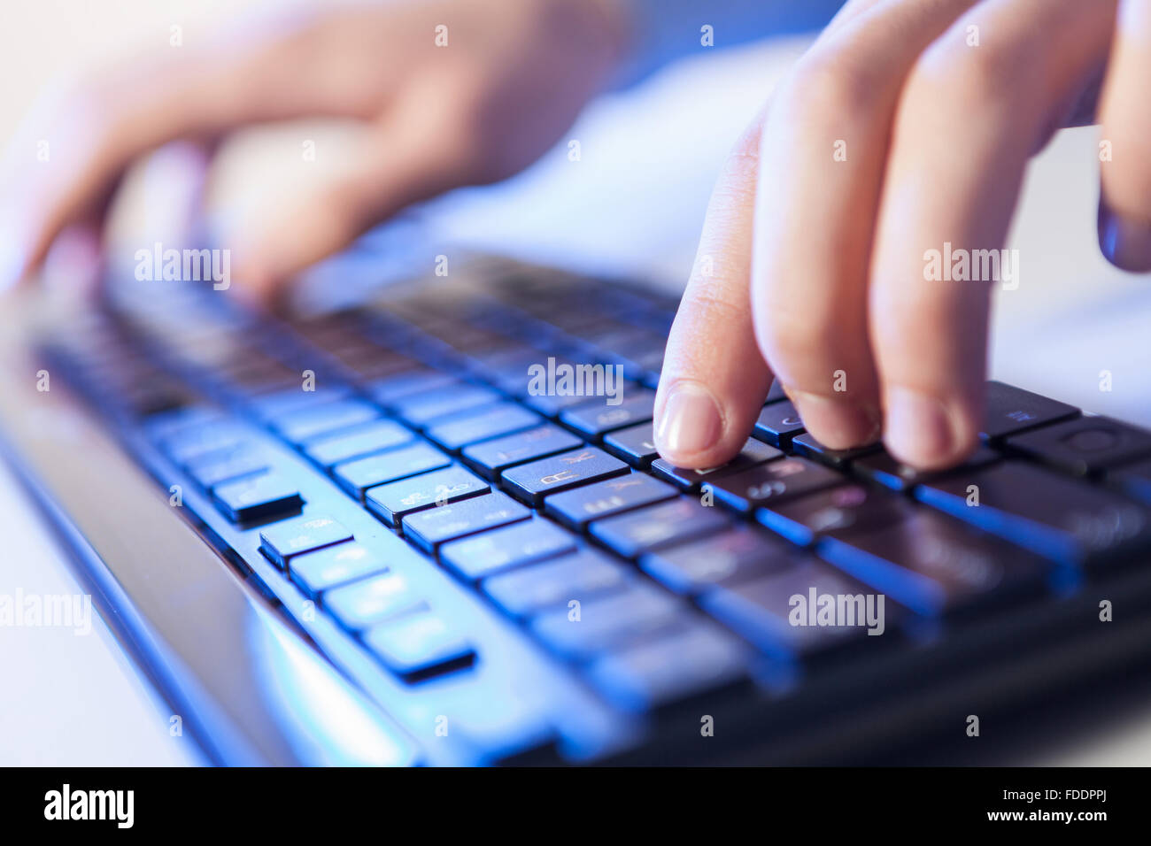 Click! Hands of a man on a keyboard with blue backlighting Stock Photo ...