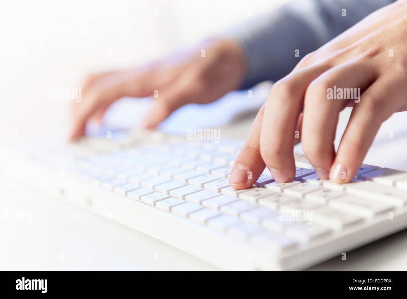 Click! Hands of a man on a keyboard with blue backlighting Stock Photo ...