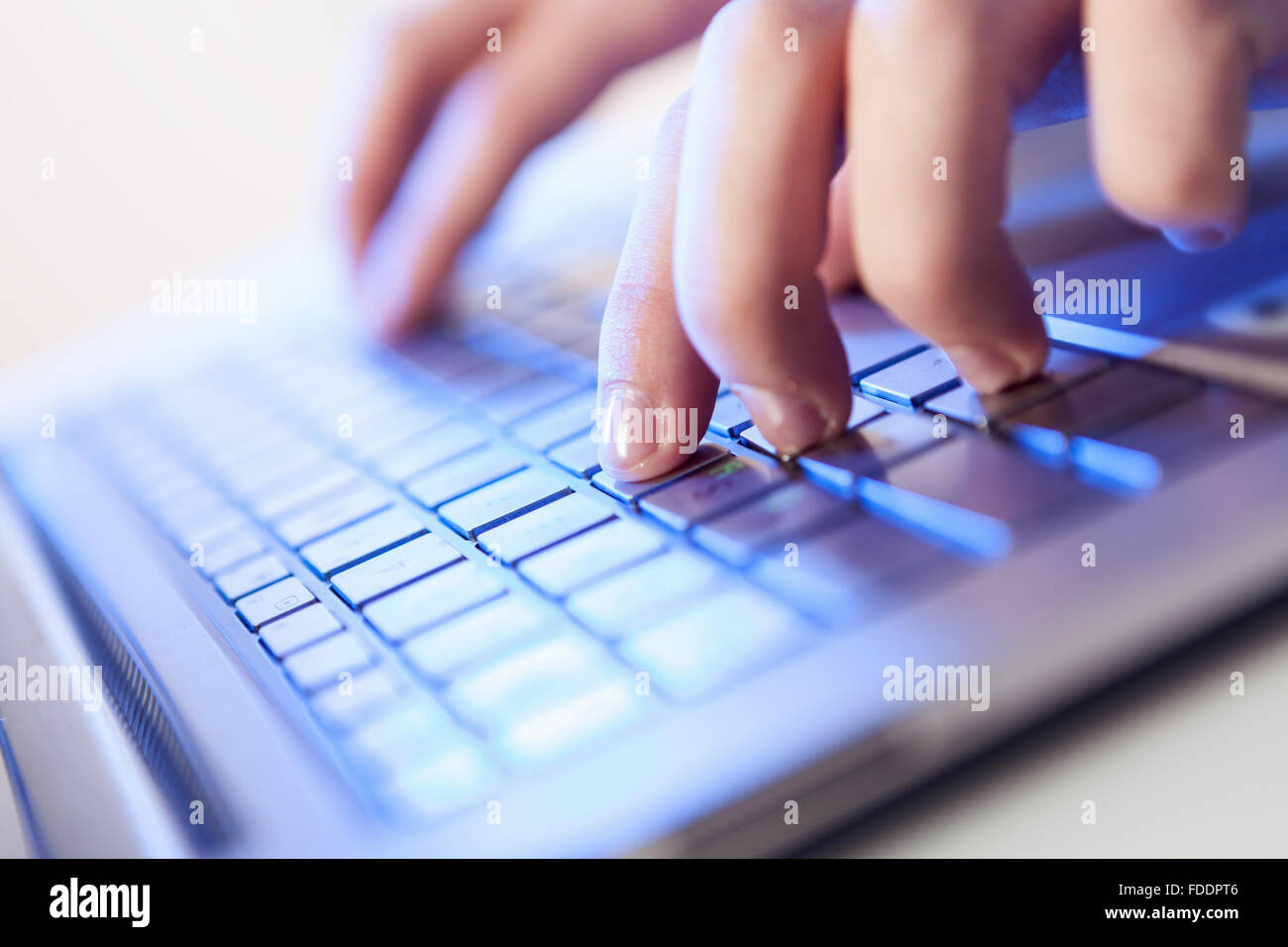 Click! Hands of a man on a keyboard with blue backlighting Stock Photo ...